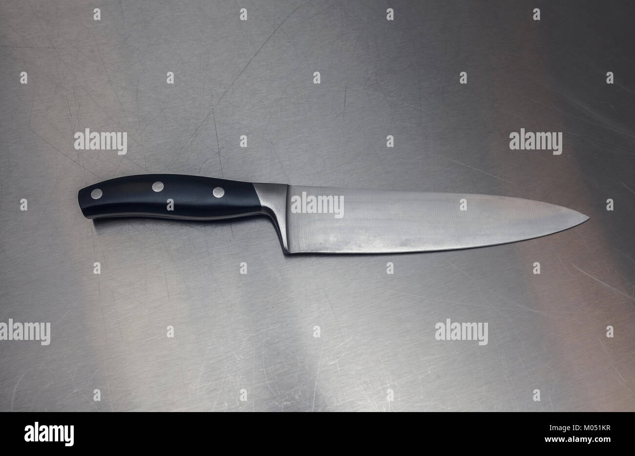big kitchen knife on a metal table, close up Stock Photo - Alamy