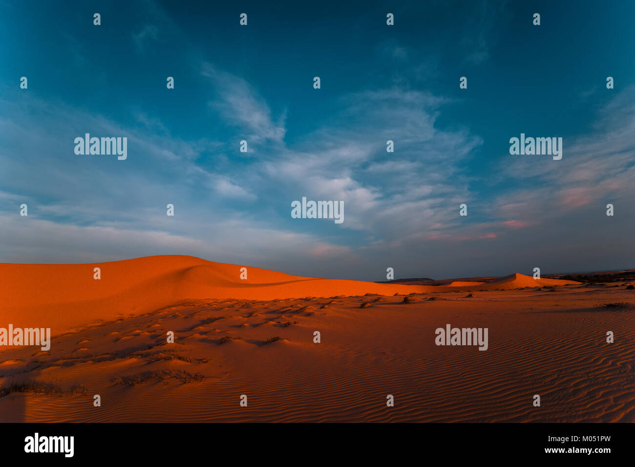 Lonely sand dunes under amazing evening sunset sky at drought desert ...