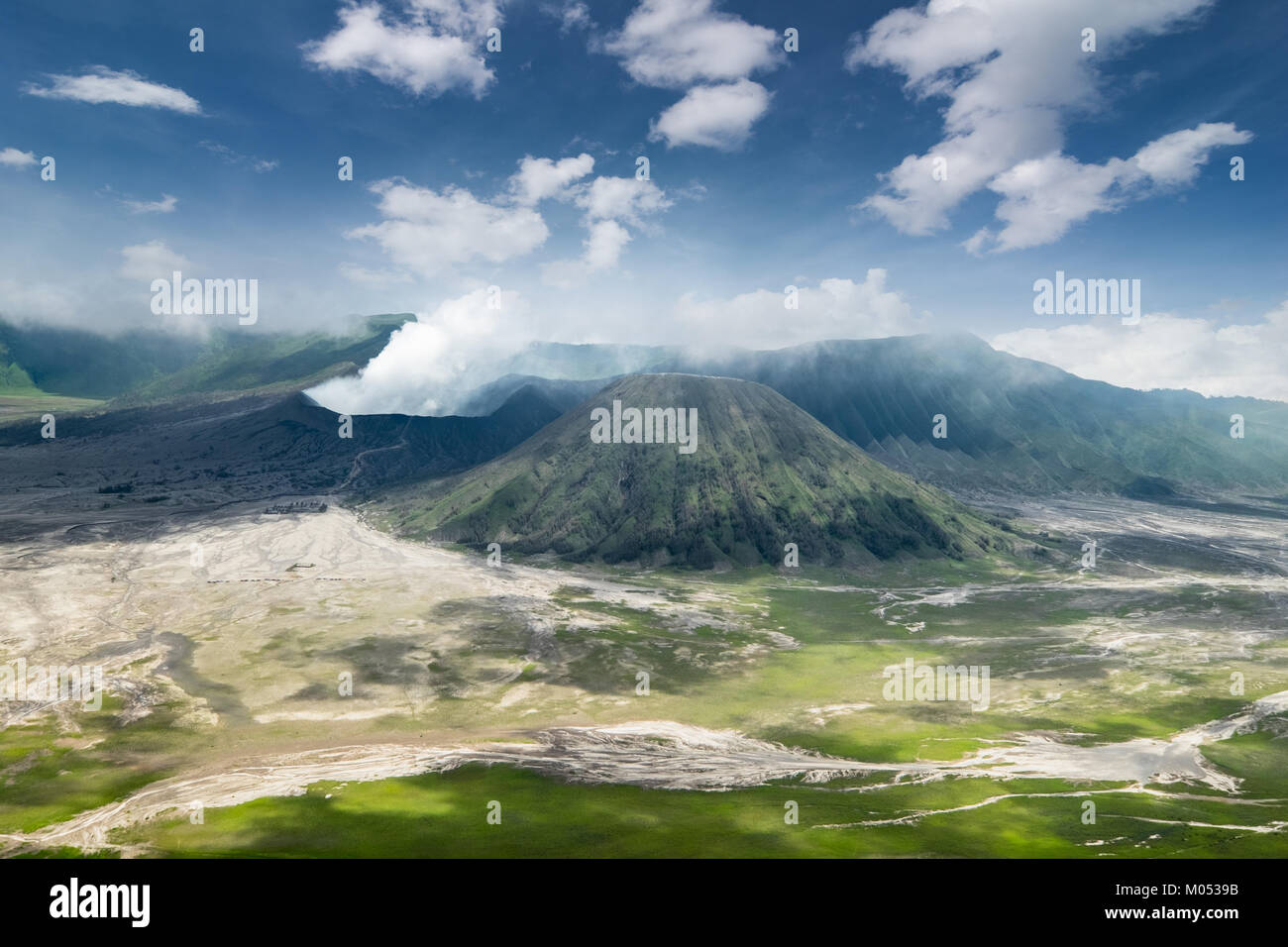 Clouds of smoke coming from crater of Mount Bromo and drifting by ...