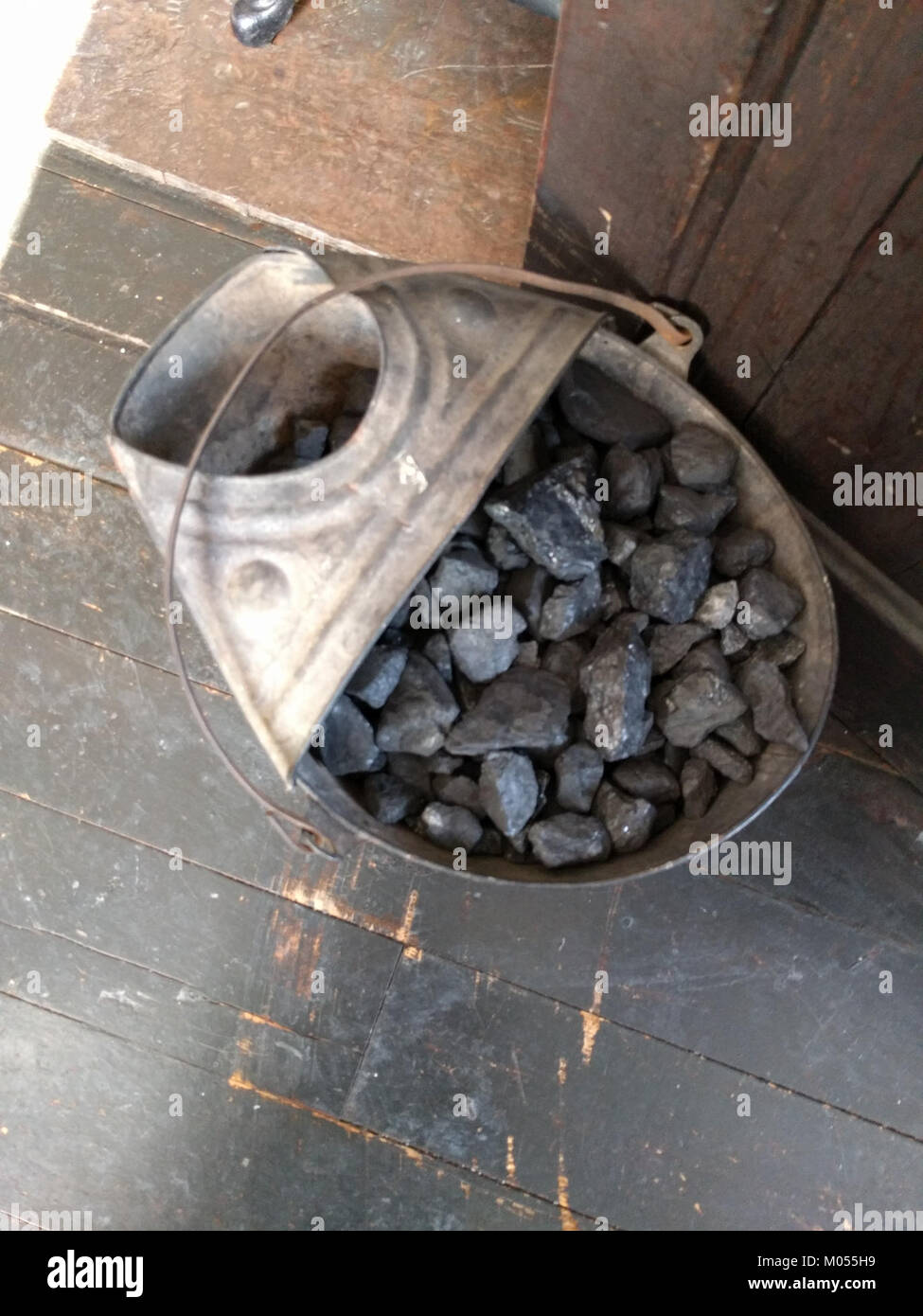 A bucket filled with coal, a staple fuel used historically for heating ...