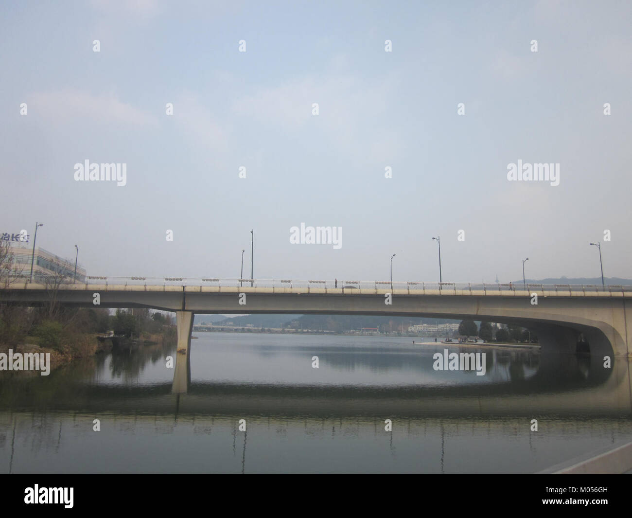 A bridge spans over Meixi Lake, showcasing the beauty of this tranquil ...