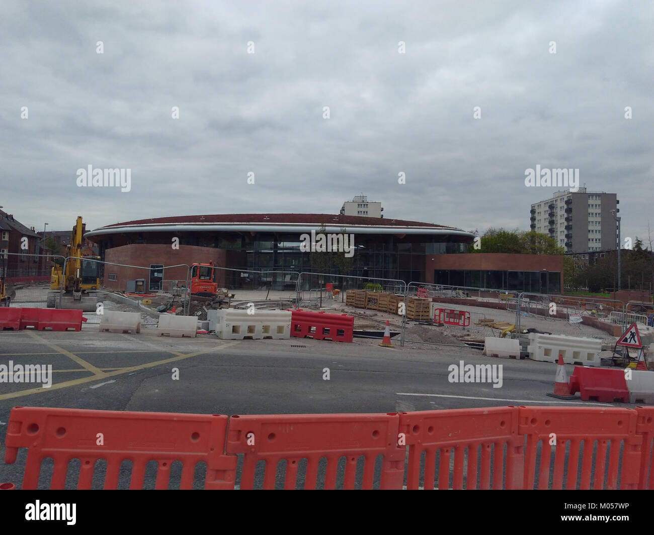 Photograph of the construction of a bus station, showing workers and ...