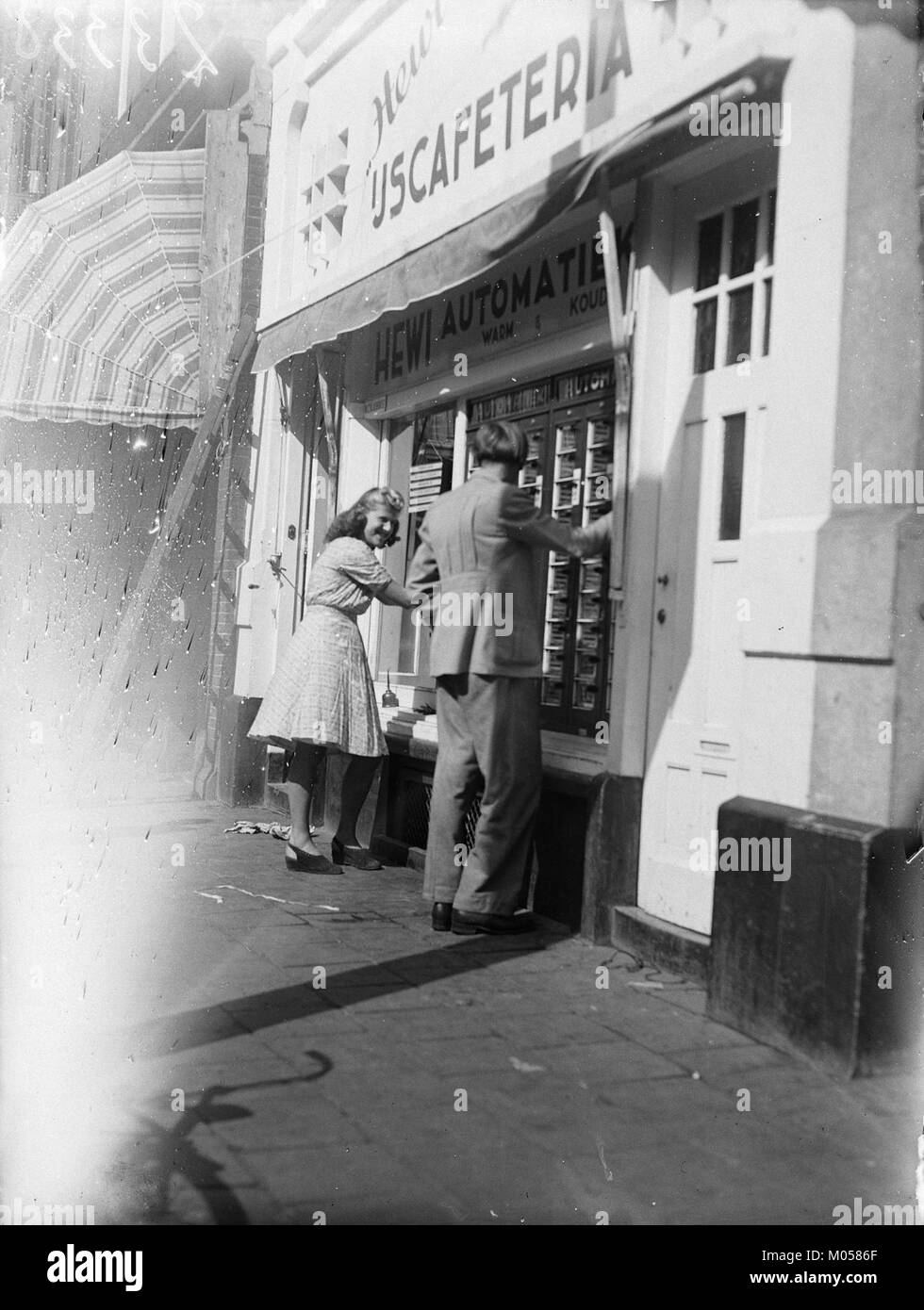 This image features a Dutch cafeteria from the mid-20th century ...