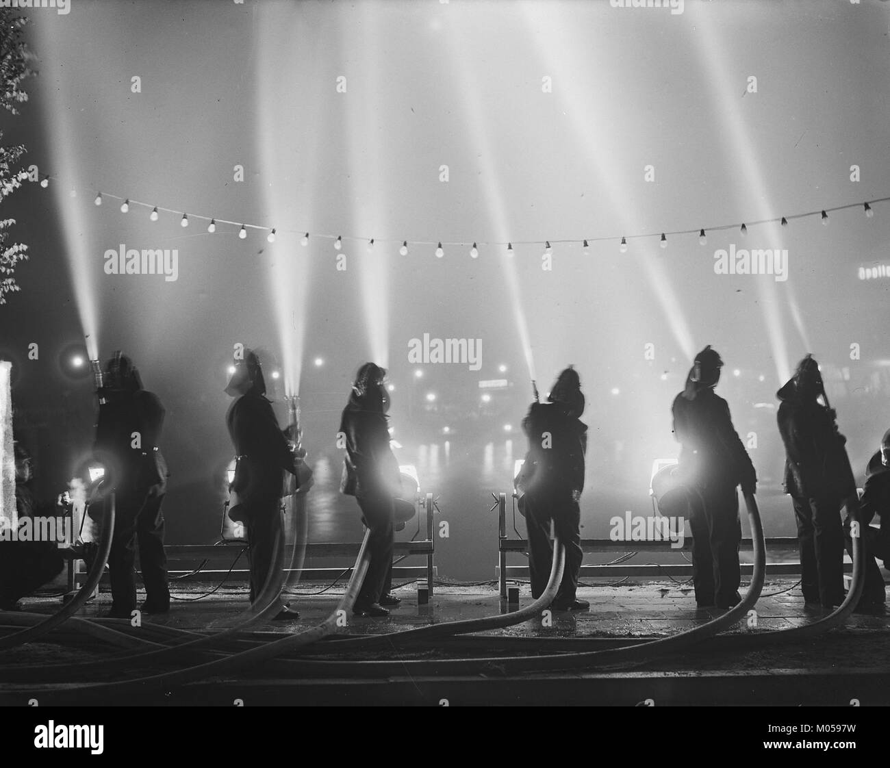 This image depicts a fire brigade demonstration with lighting effects ...