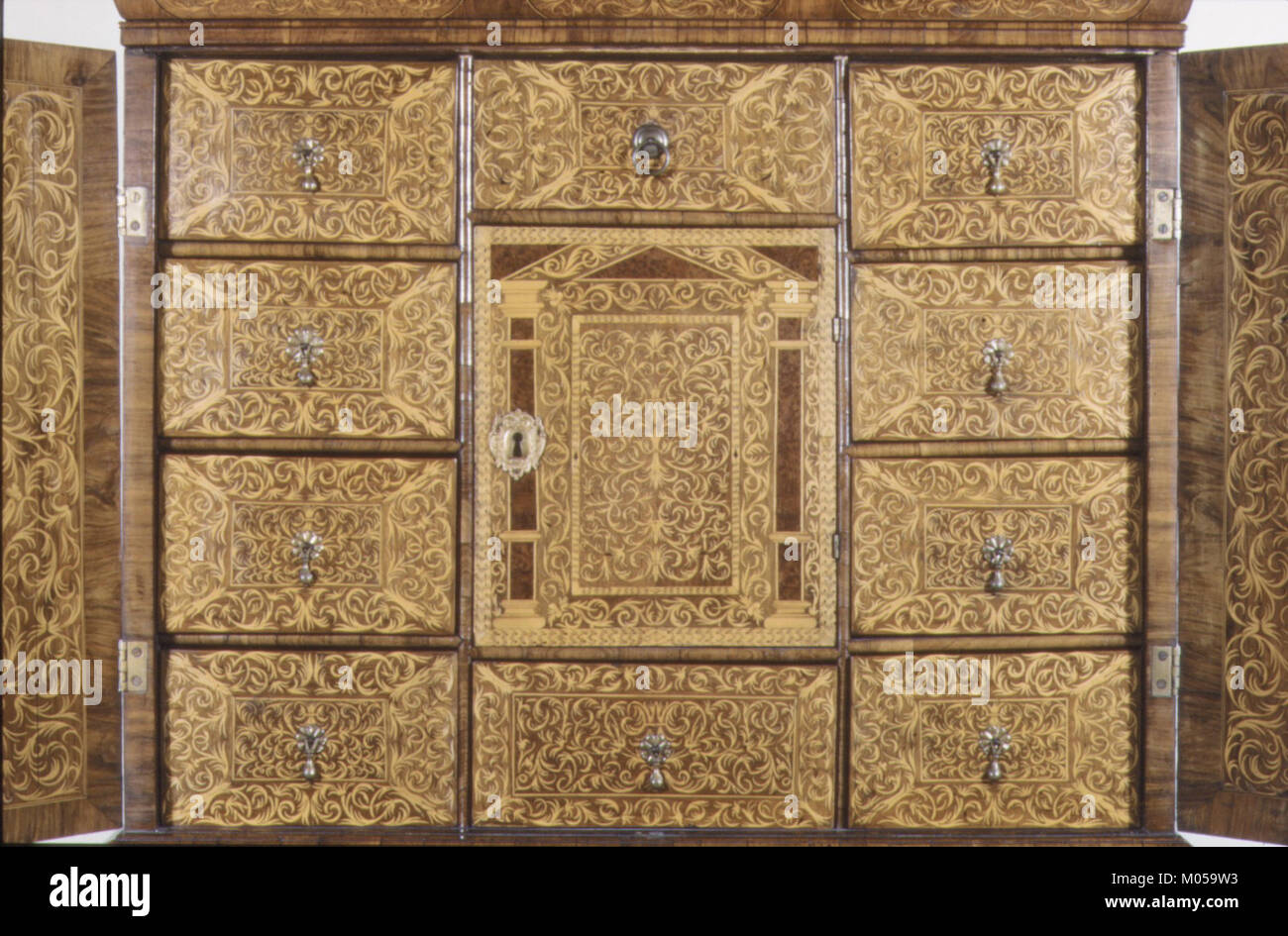 This cabinet, part of the MET collection, is displayed on a stand and ...