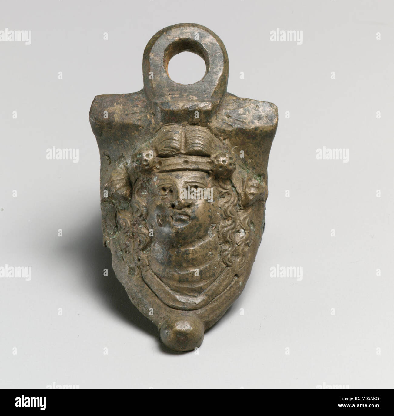 This bronze handle attachment is an artifact from the MET collection ...