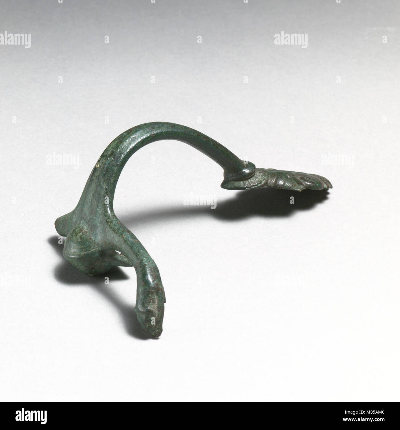 The bronze handle of a vessel, identified as MET DP21108, is an example ...
