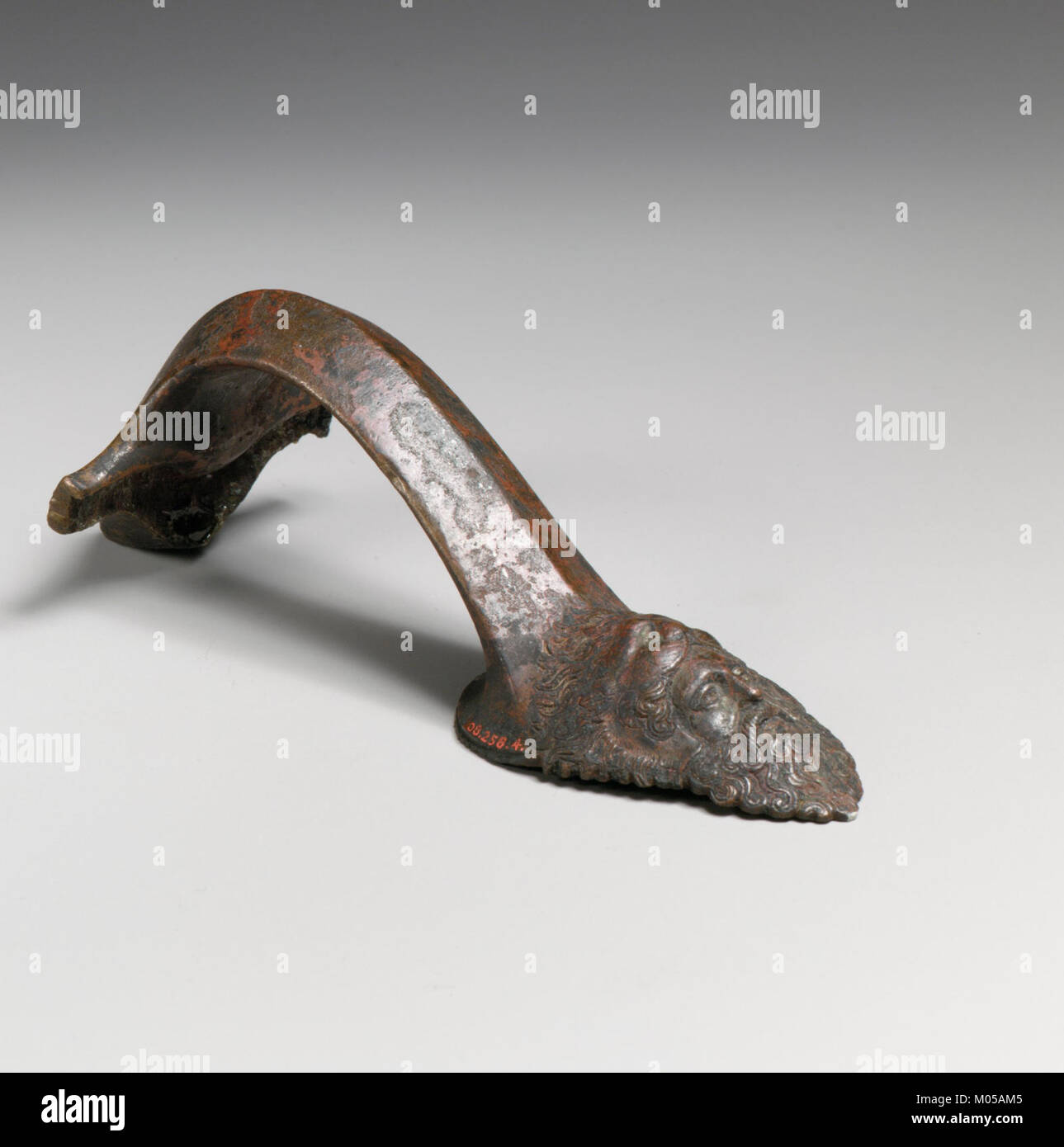 This bronze handle is part of an oinochoe, a type of ancient Greek jug ...