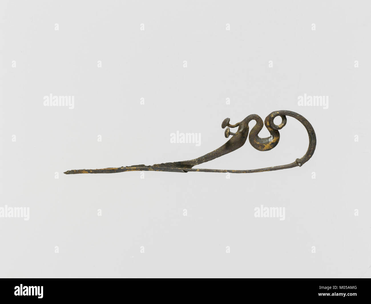 This bronze dragon-type fibula, or safety pin, is an ancient artifact ...