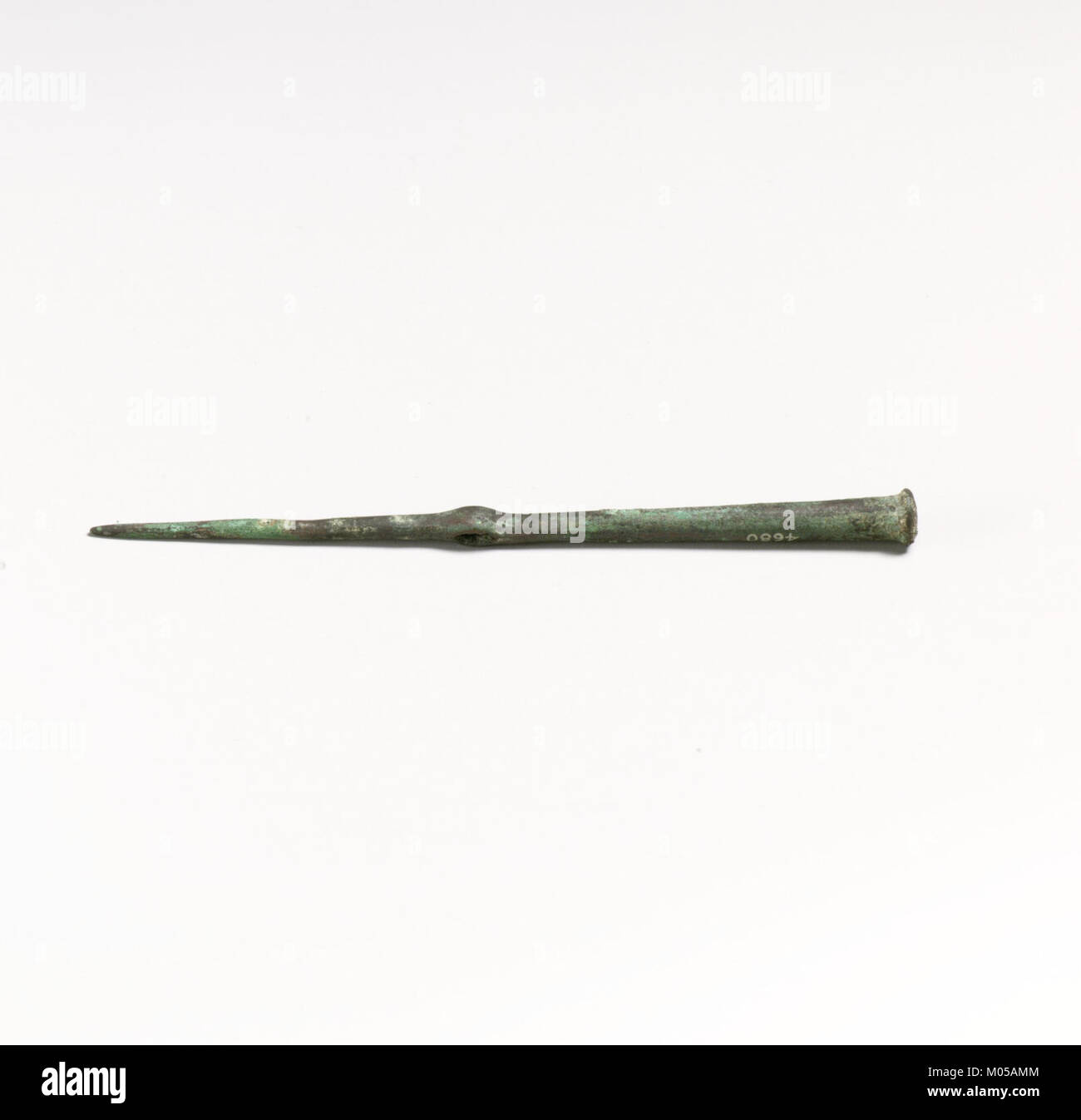 This bronze eyelet-type pin is a historical artifact, featured in the ...