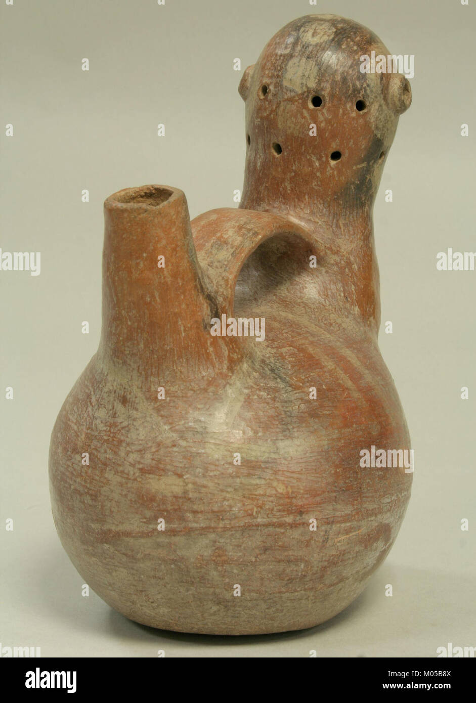 This artistic piece features a bridge and spout bottle shaped like a ...