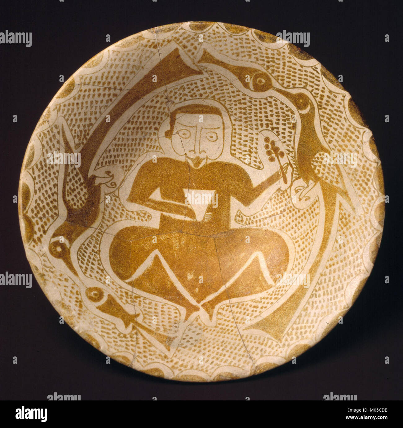 This bowl, cataloged at the Metropolitan Museum of Art, depicts a man ...
