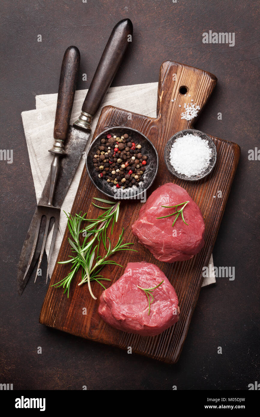 Raw fillet steak cooking on stone table. Top view Stock Photo - Alamy