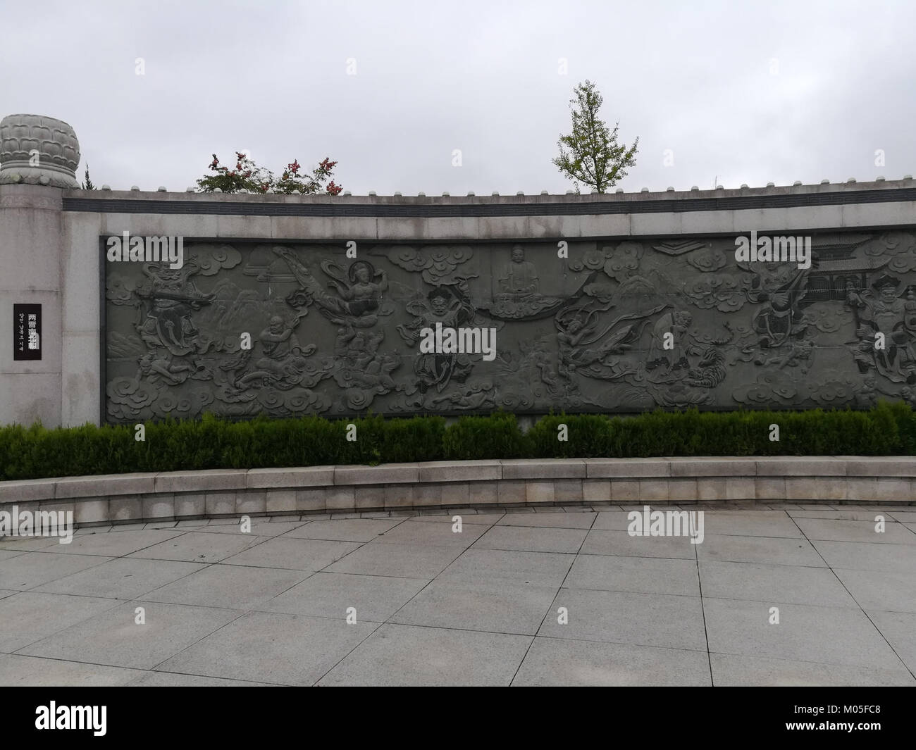 The Buddha relief wall at Miyin Temple showcases intricate carvings of ...