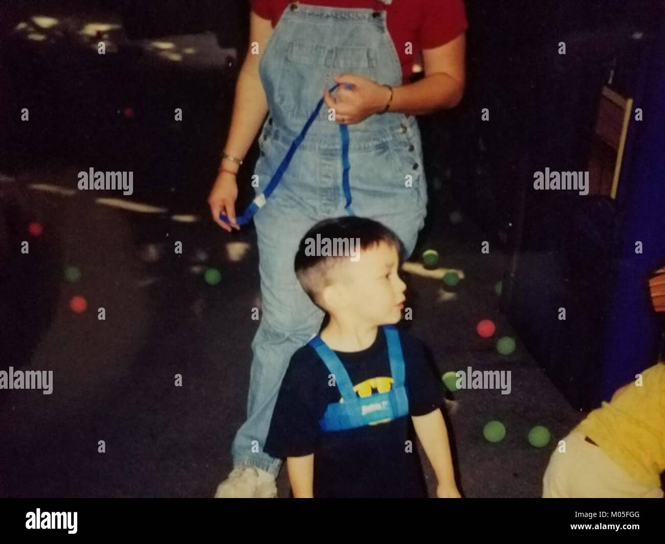 A photograph featuring a boy wearing a harness, capturing a moment that ...