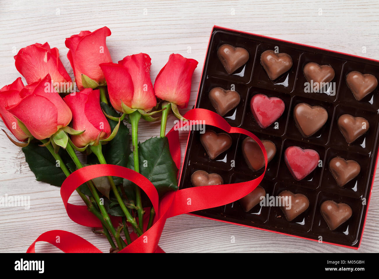 Valentines day greeting card with red roses and heart shaped chocolate ...
