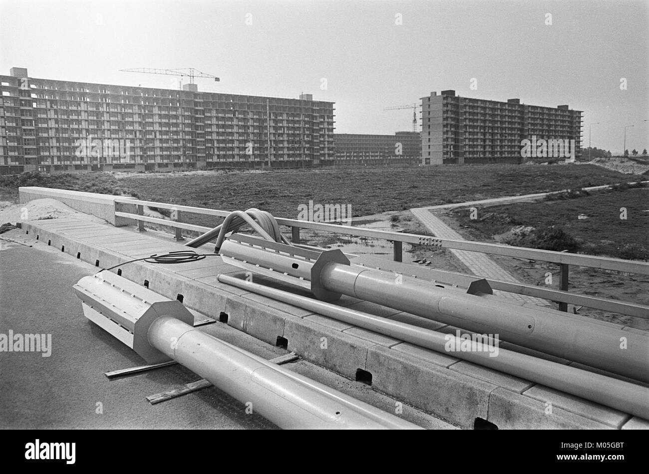 The image depicts a construction site with apartment buildings and a ...