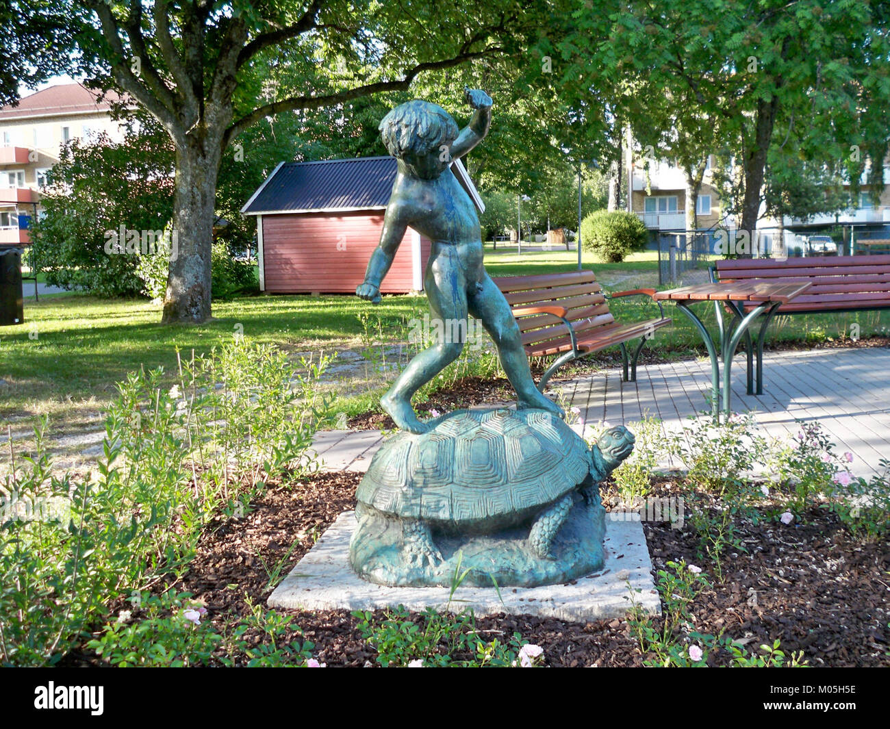 This image depicts a boy interacting with a turtle, illustrating a ...