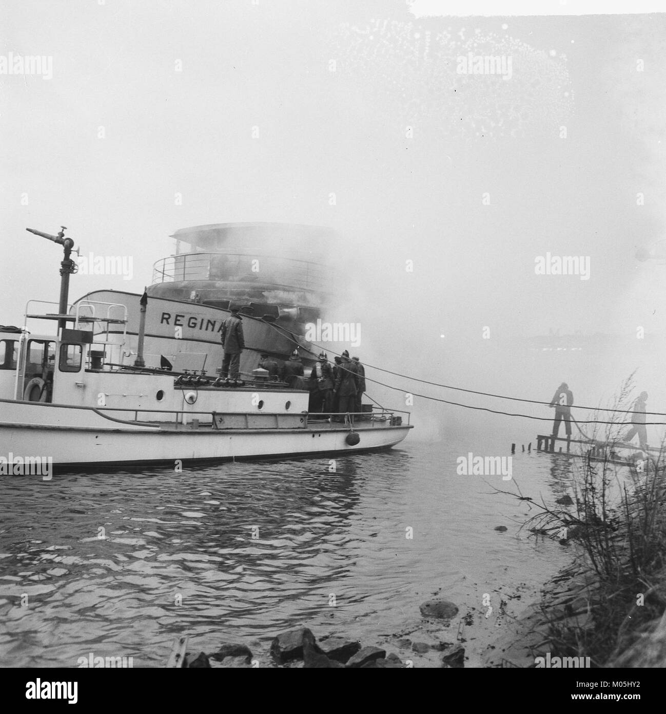 This image depicts the fire brigade fighting the fire on the passenger ...