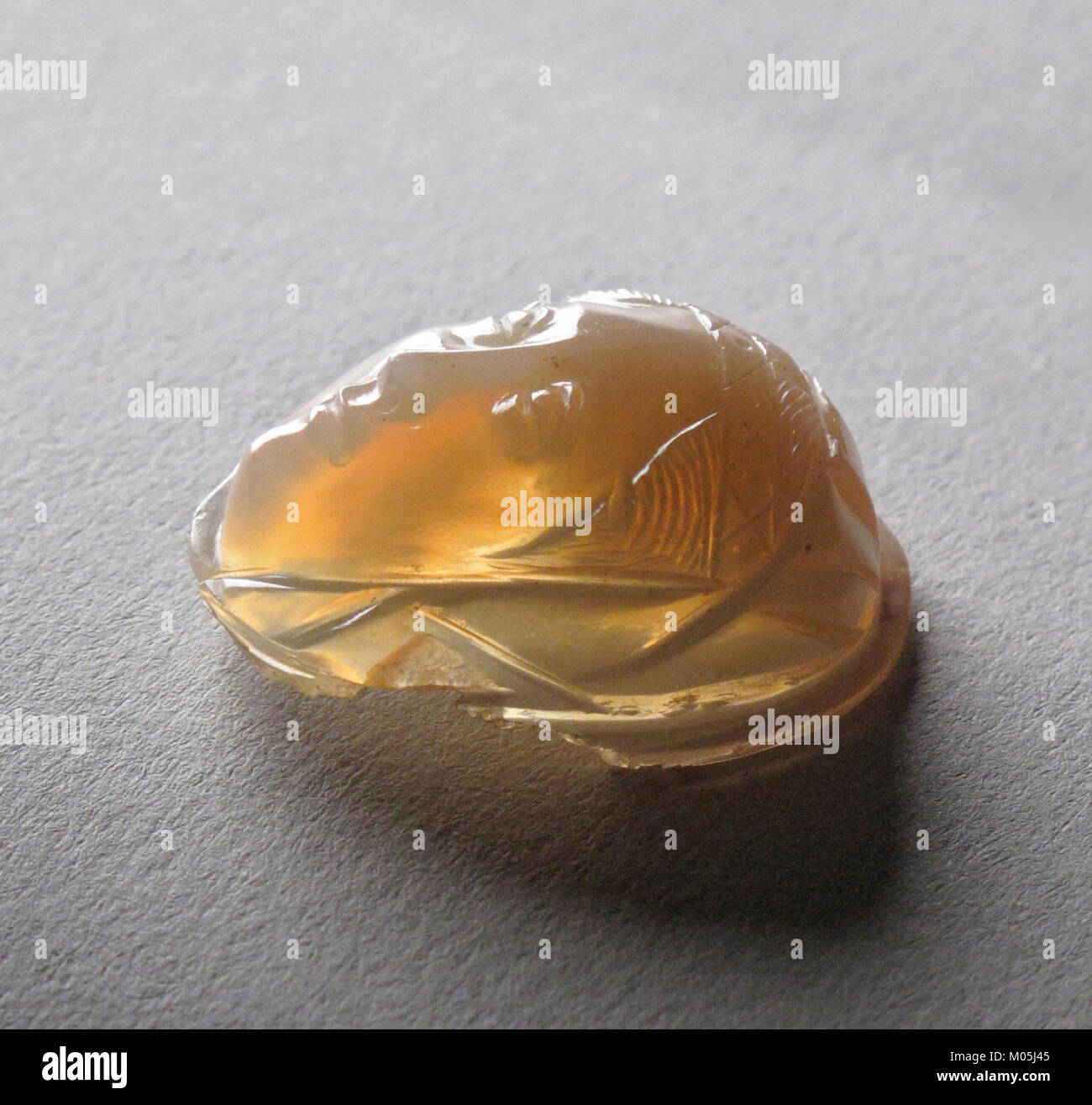 This cameo features the head of a female saint, adorned with a wimple ...