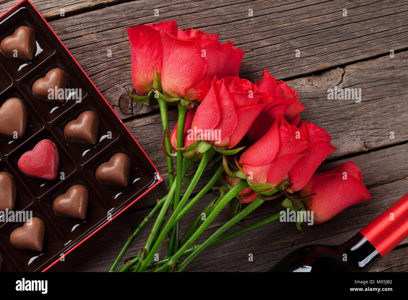 Valentines day greeting card with red roses and heart shaped chocolate ...