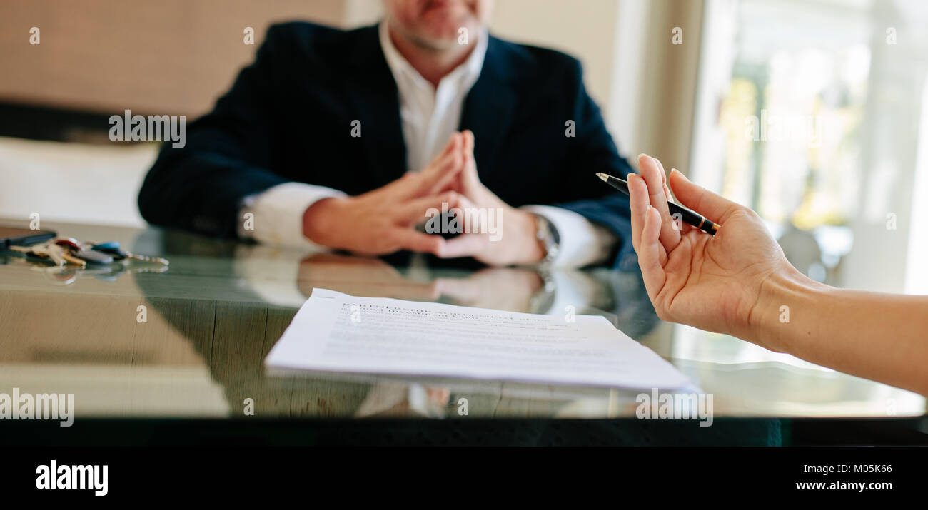 Woman in discussion with real estate agent during a new property deal ...