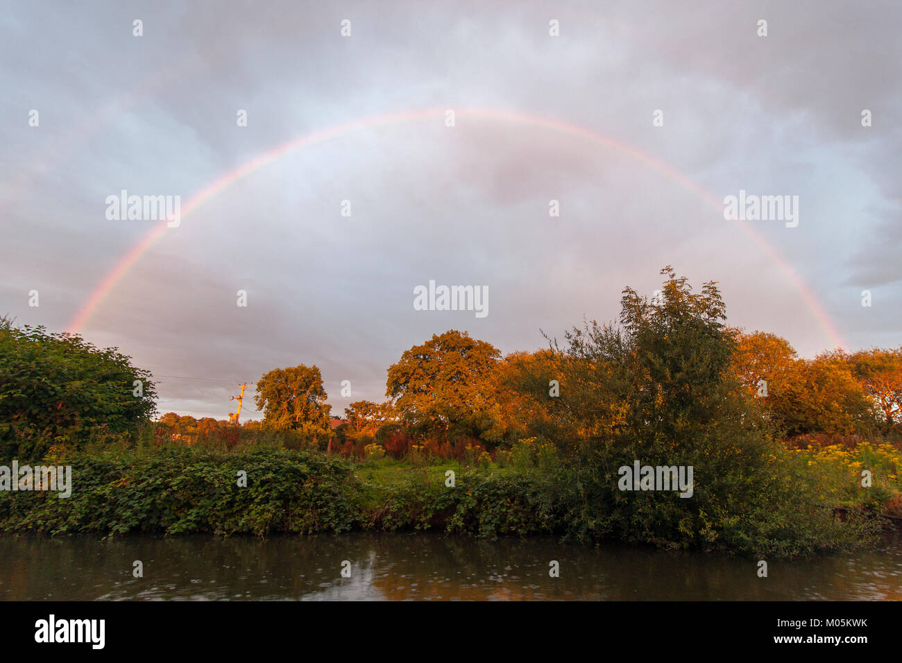 Rainbow with Secondary Over English Countryside Stock Photo - Alamy