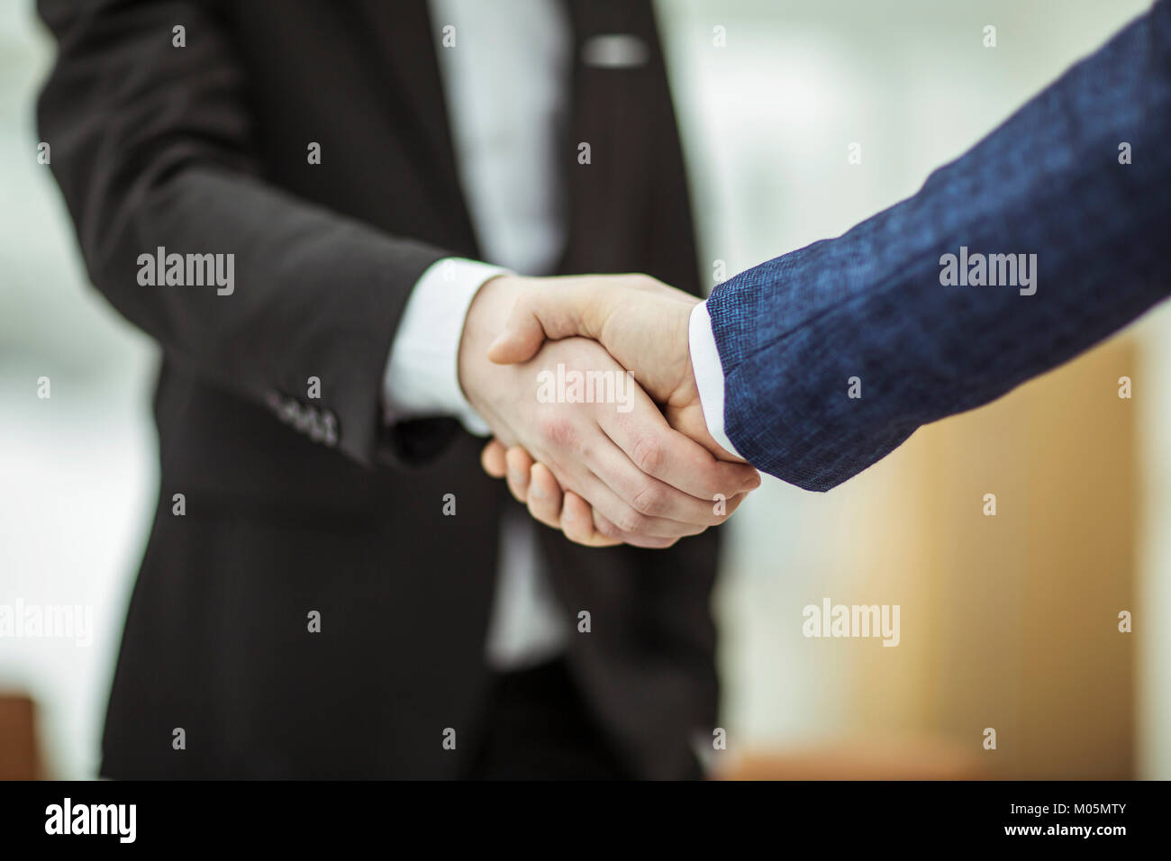 concept of a reliable partnership : a handshake of business partners ...