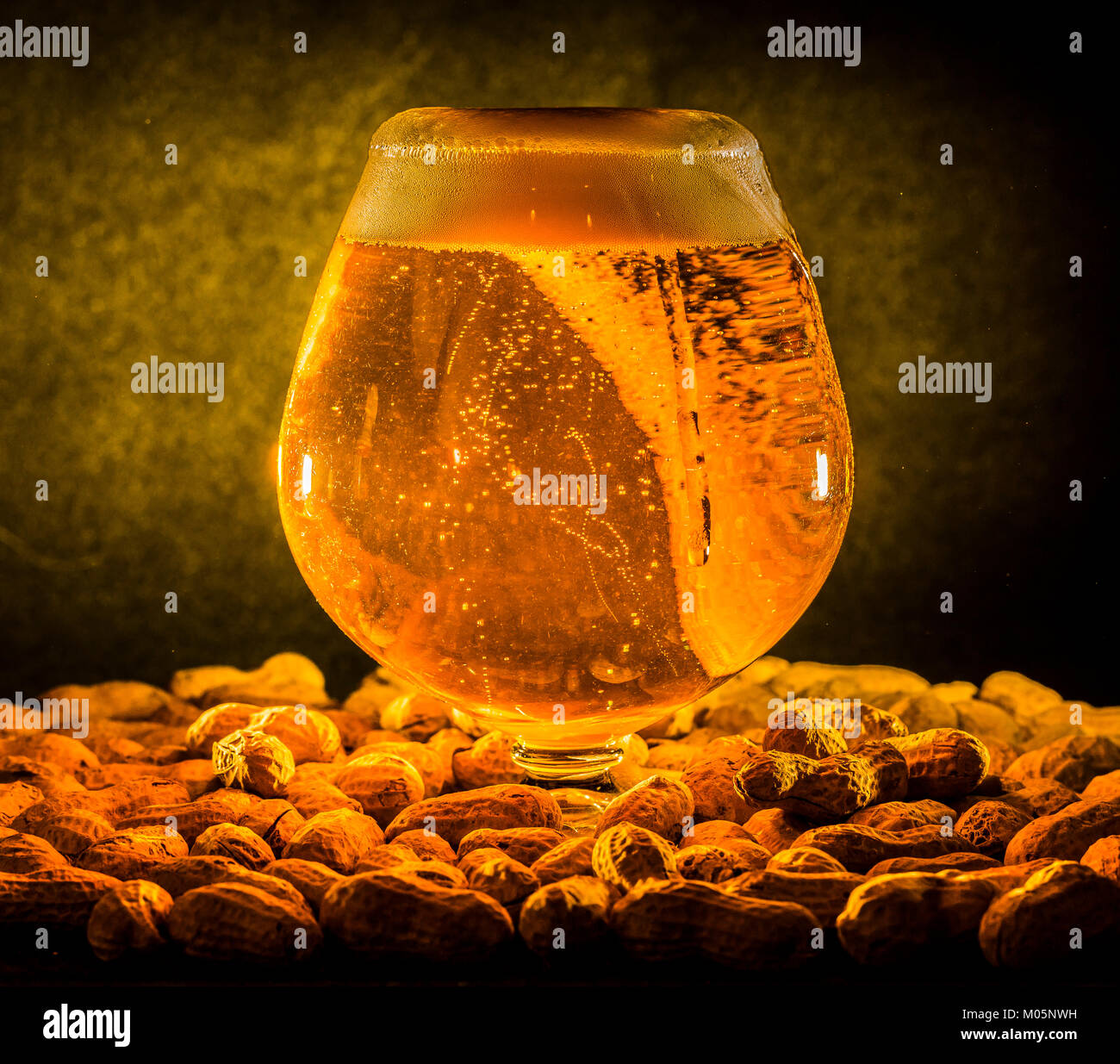 goblet of draft draught beer surrounded by nuts Stock Photo - Alamy