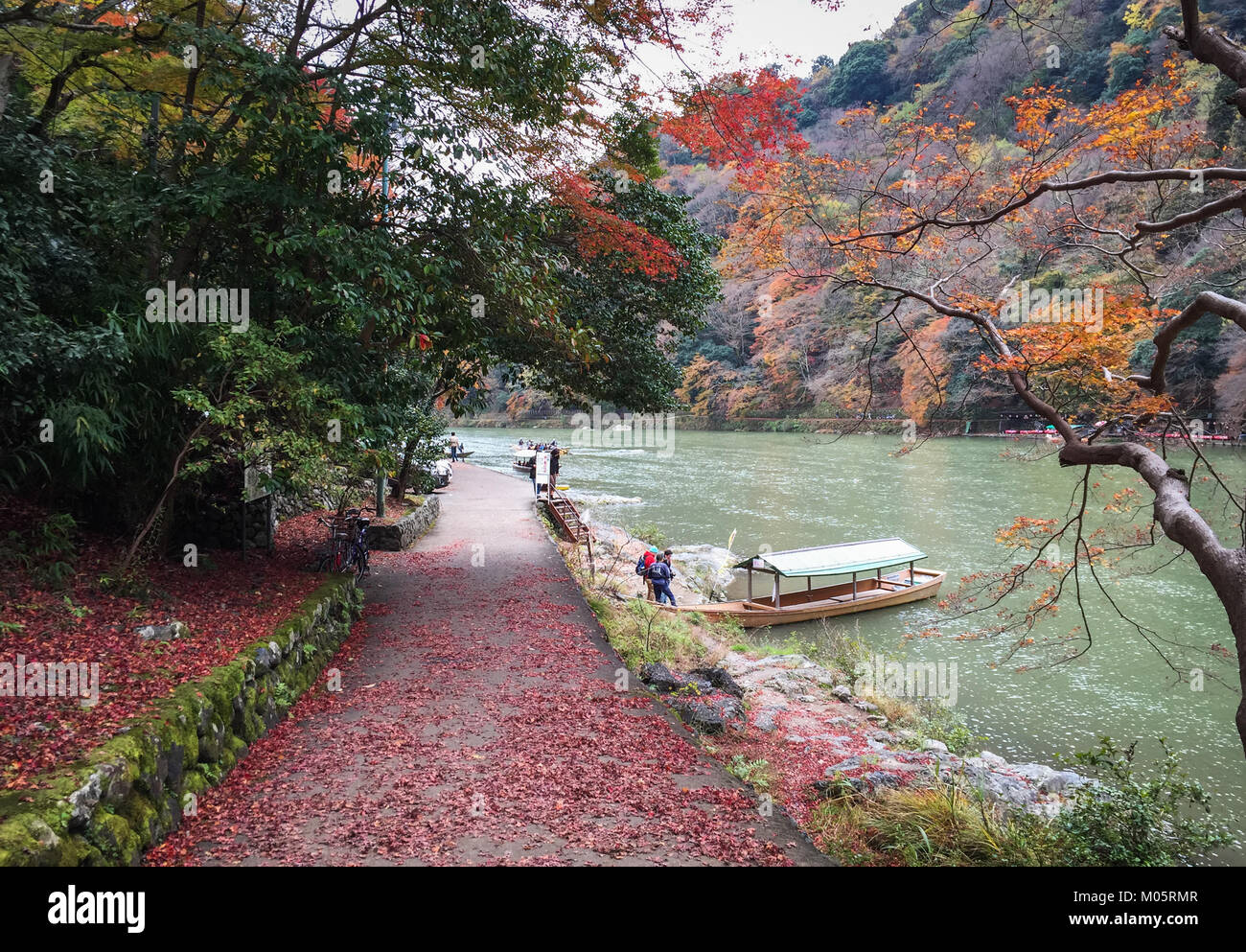 Boats ride along River Oi at autumn in Arashiyama, Japan Stock Photo ...