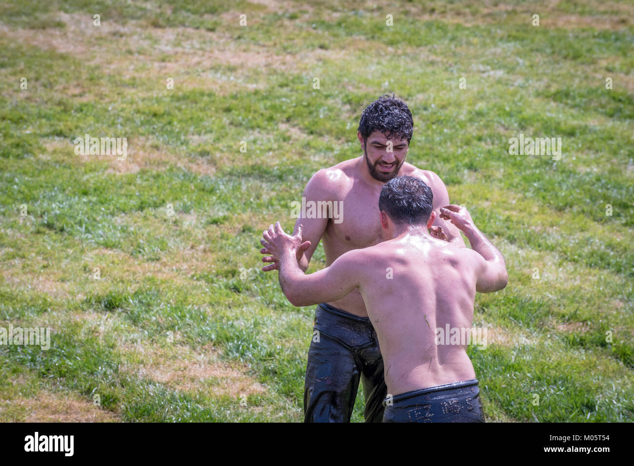Unidentified Turkish people perform oil wrestling.Oil wrestling or ...