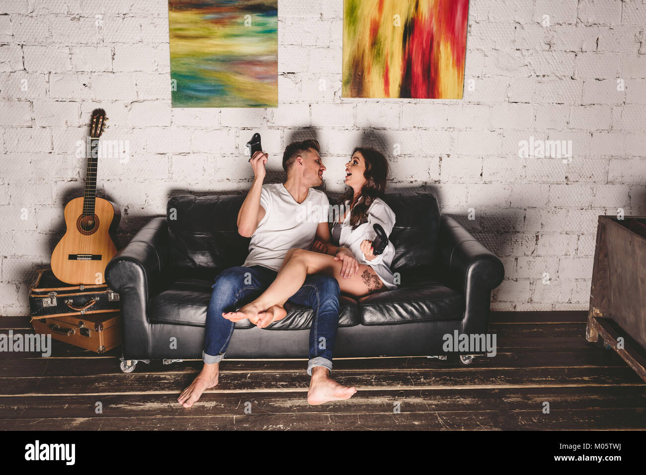 Happy couple playing video games on console and having fun Stock Photo ...