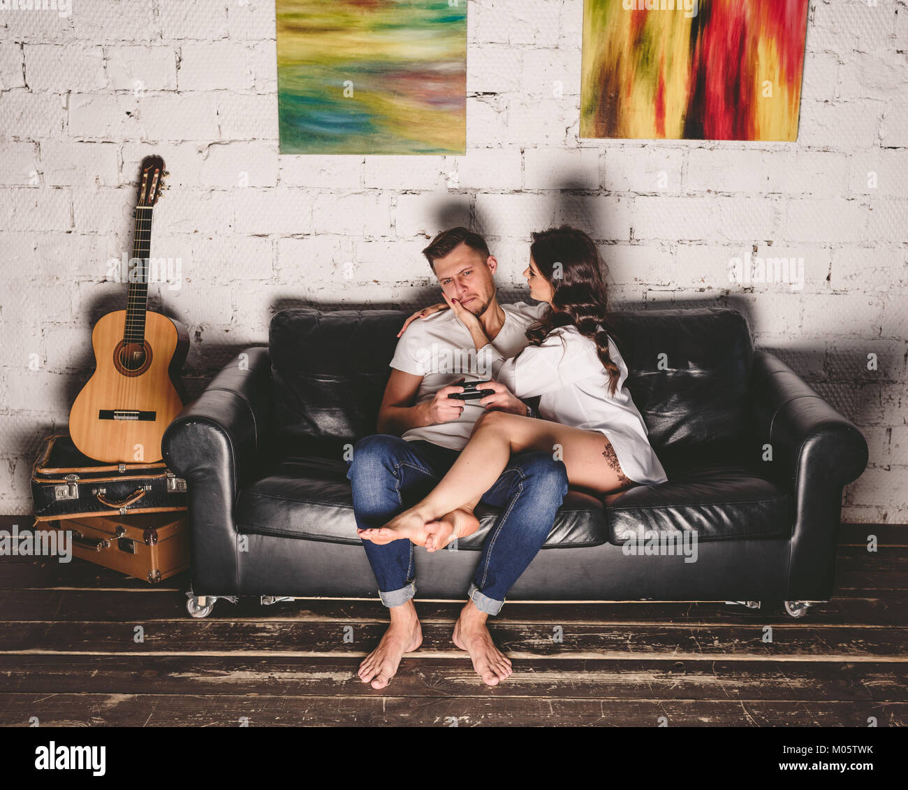 Happy couple playing video games on console and having fun Stock Photo ...