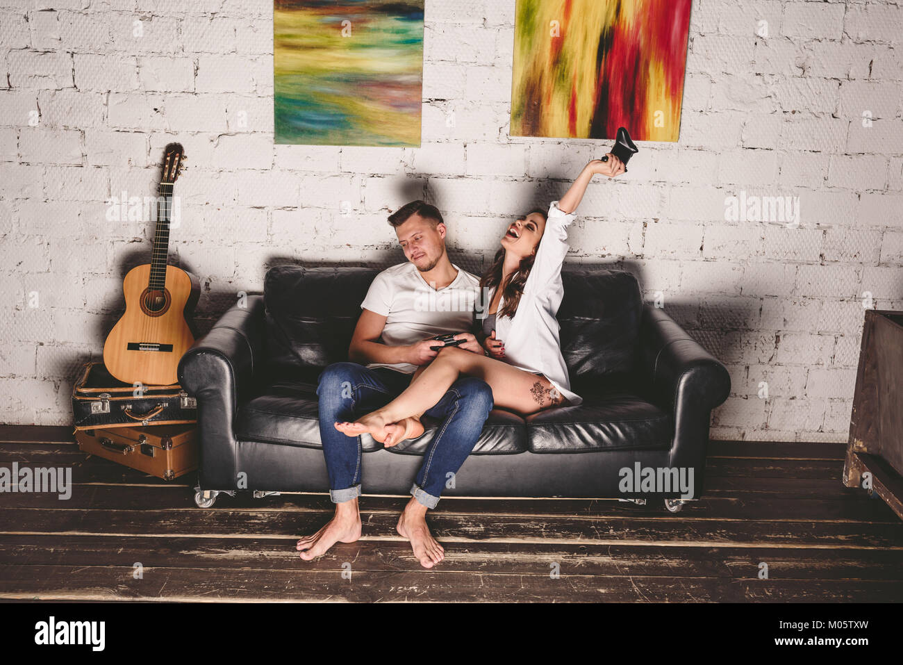 Happy couple playing video games on console and having fun Stock Photo ...
