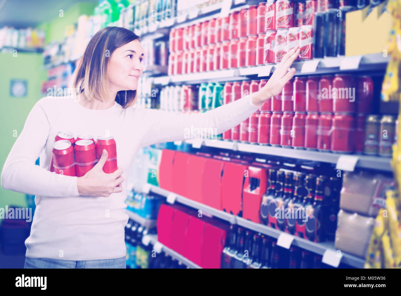 female shopper searching for beer pack in supermarket Stock Photo - Alamy