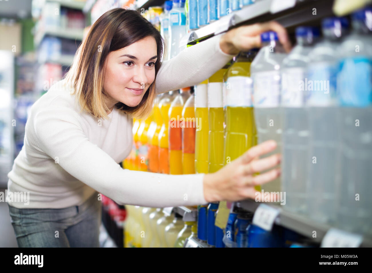 Girl customer looking for the refreshing beverages at supermarket Stock ...