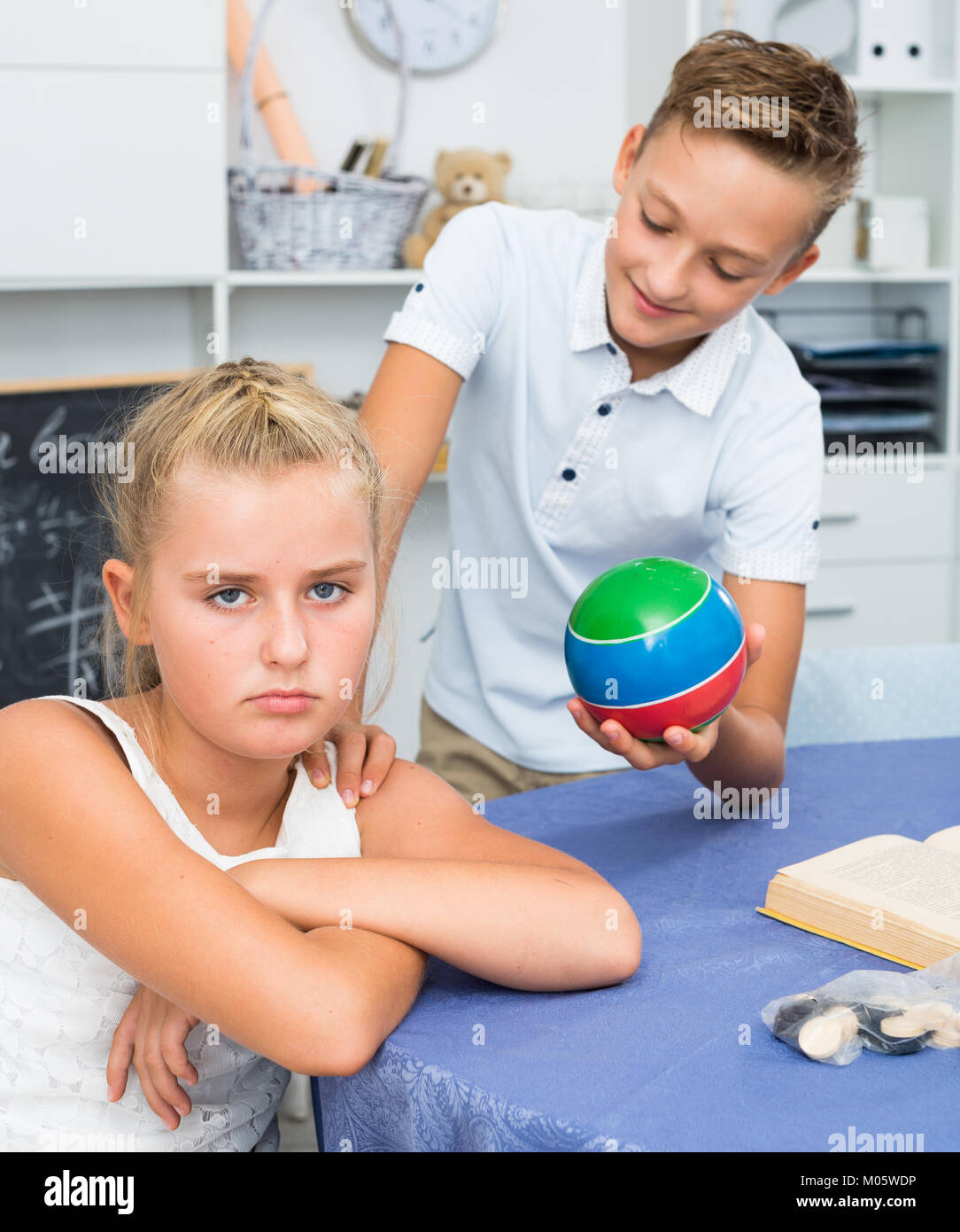 Boy is excusing for the offendedly girl and offering to play ball at ...