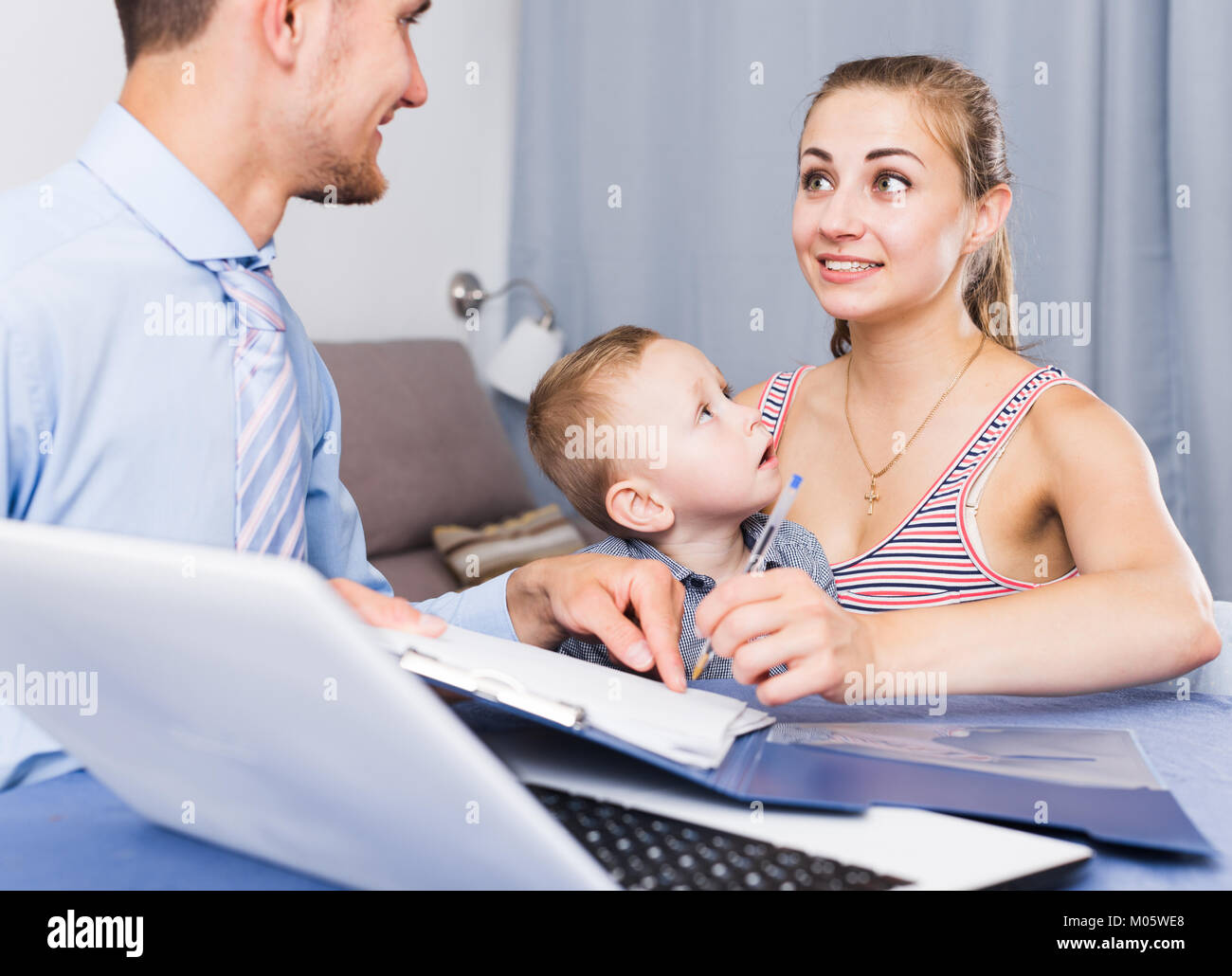 Smiling female signing documents with worker of research company Stock ...