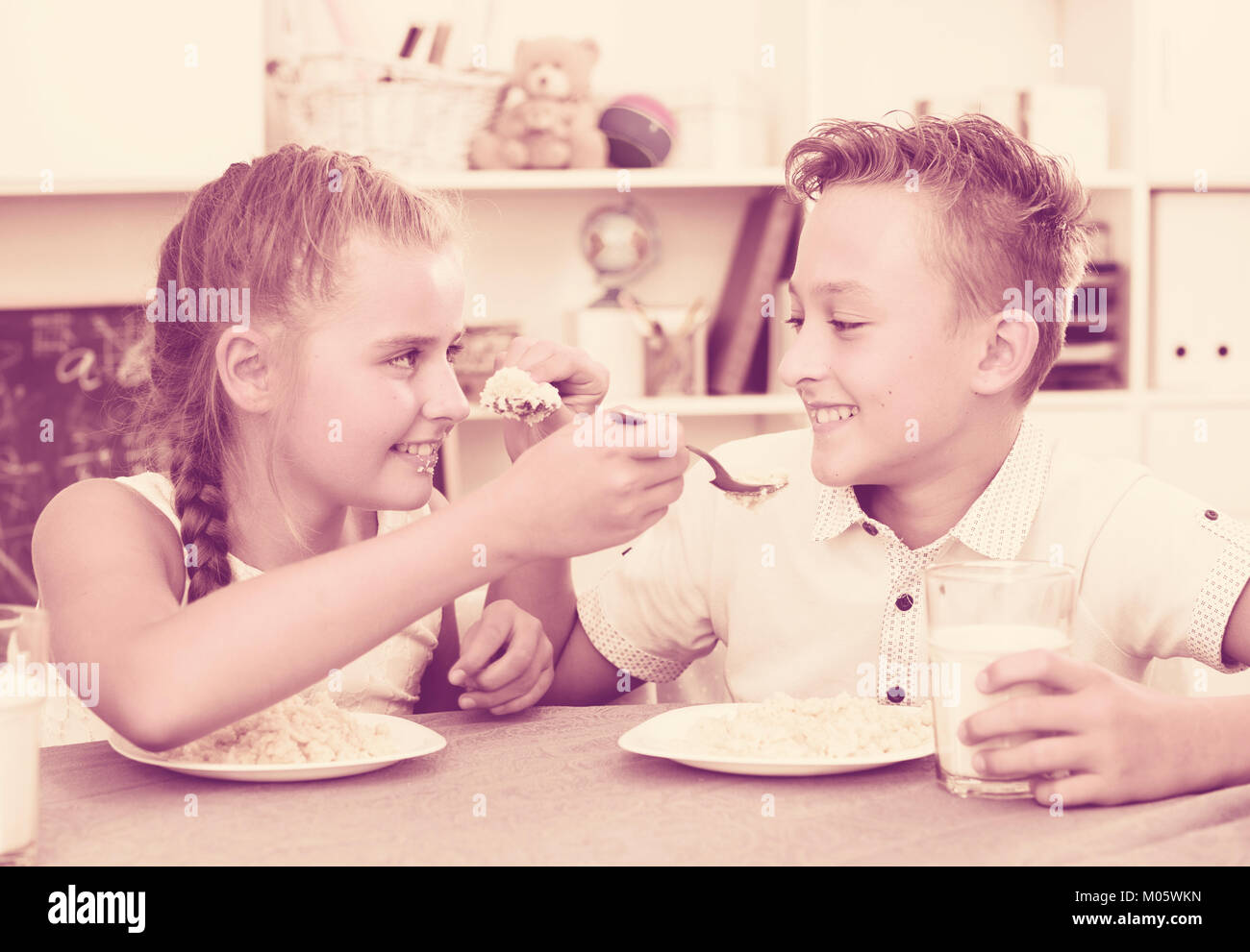 Friends are feed each other during dinner at home Stock Photo - Alamy