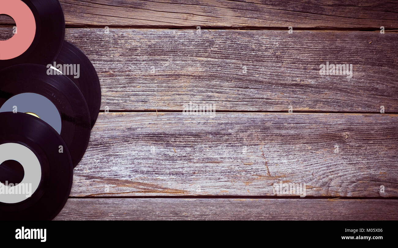 Old single vinyl records on a wooden background Stock Photo - Alamy