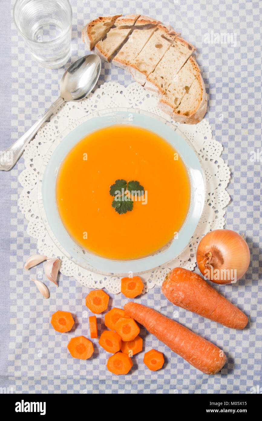 Homemade carrot soup on table cloth with onion and fruit Stock Photo ...