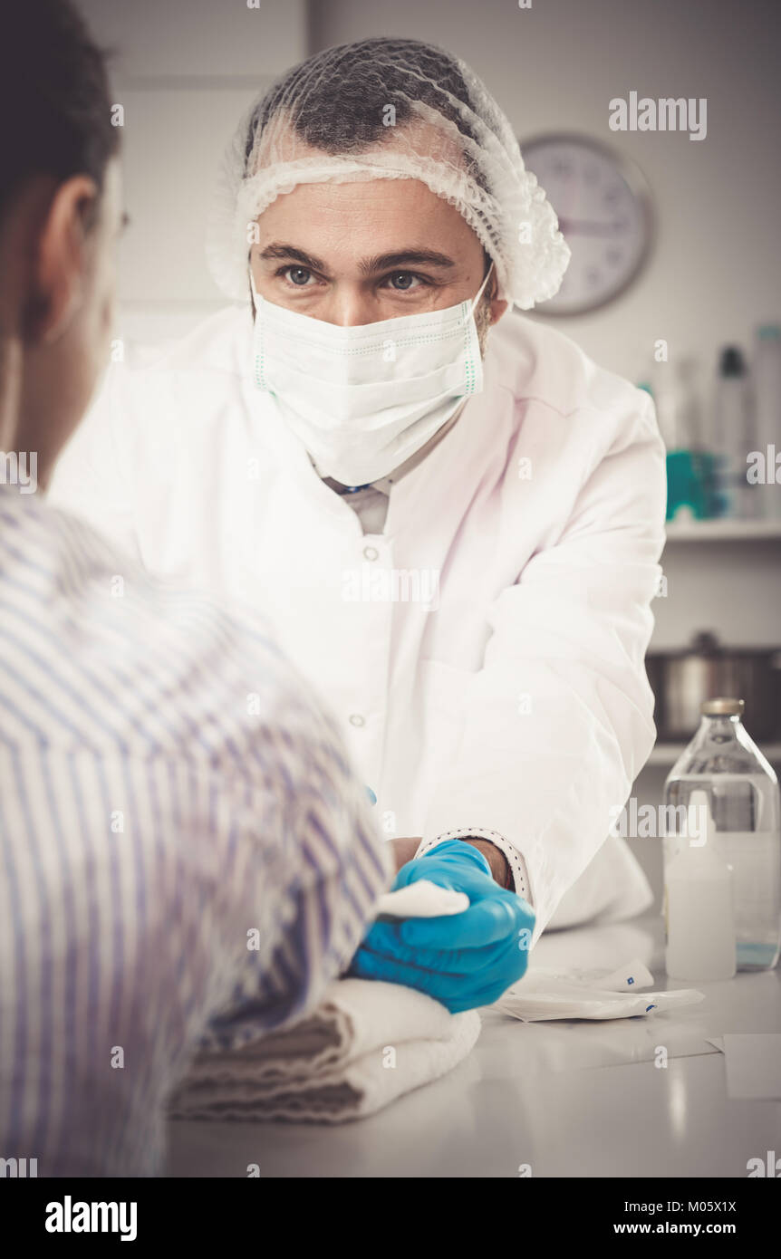 Male nurse using syringe to make injection to patient in hospital Stock ...