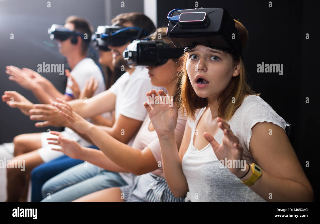 Agitated young woman experiencing with friends virtual reality Stock ...
