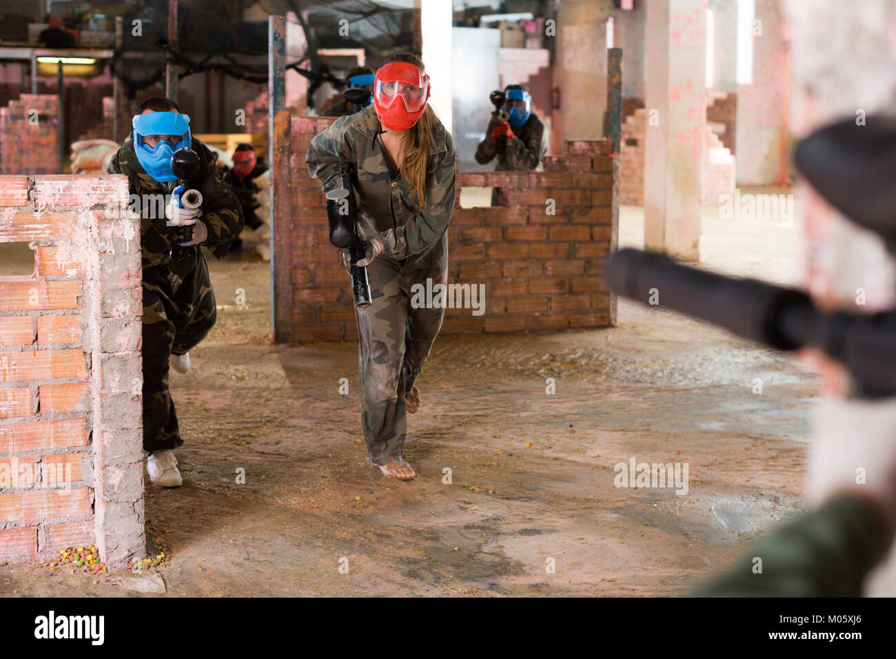 Blue and red team are having fun on the battlefiled on the paintball ...