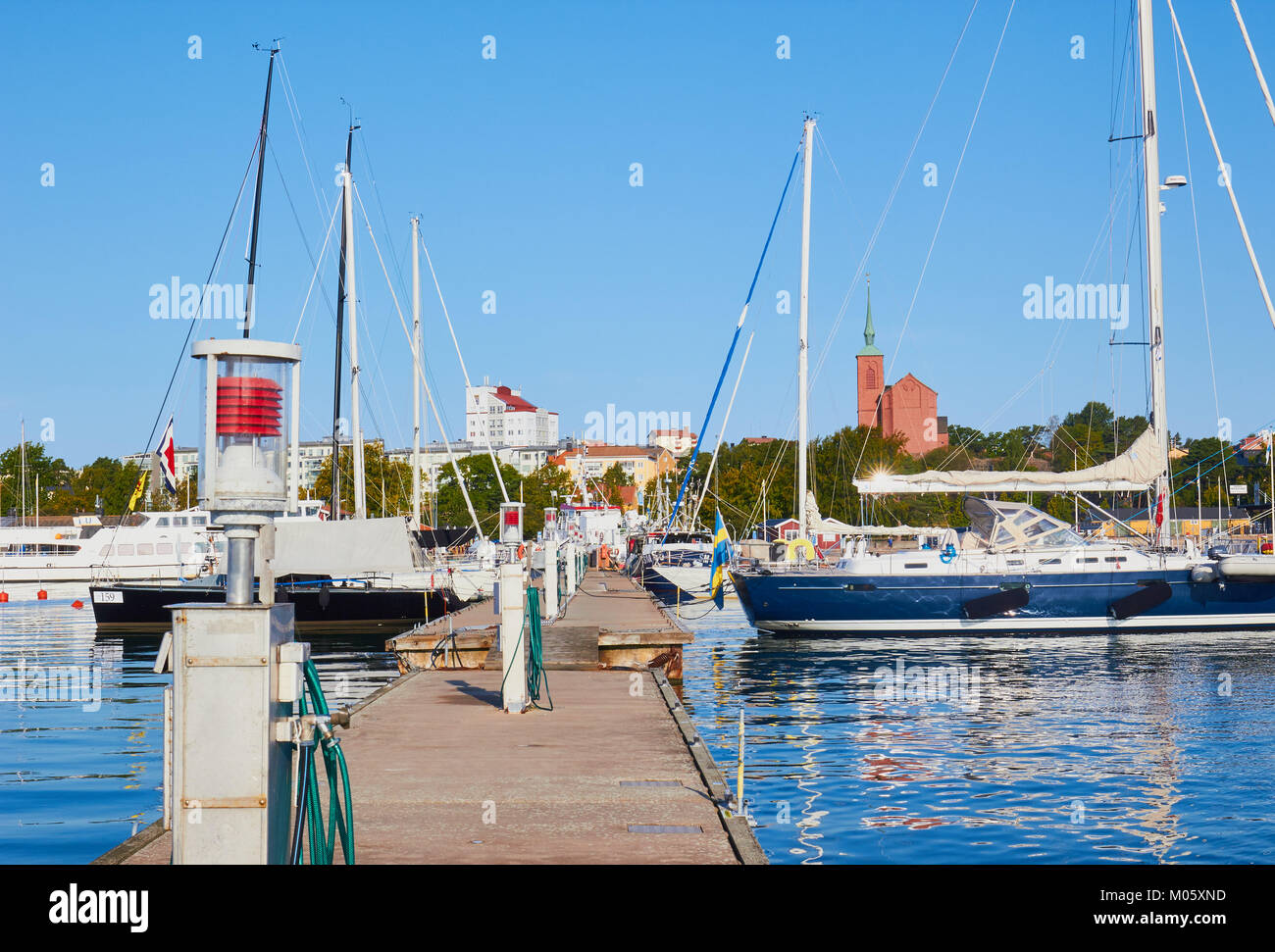 Nynashamn harbour with Nynashamn Church on a cliff in the background ...