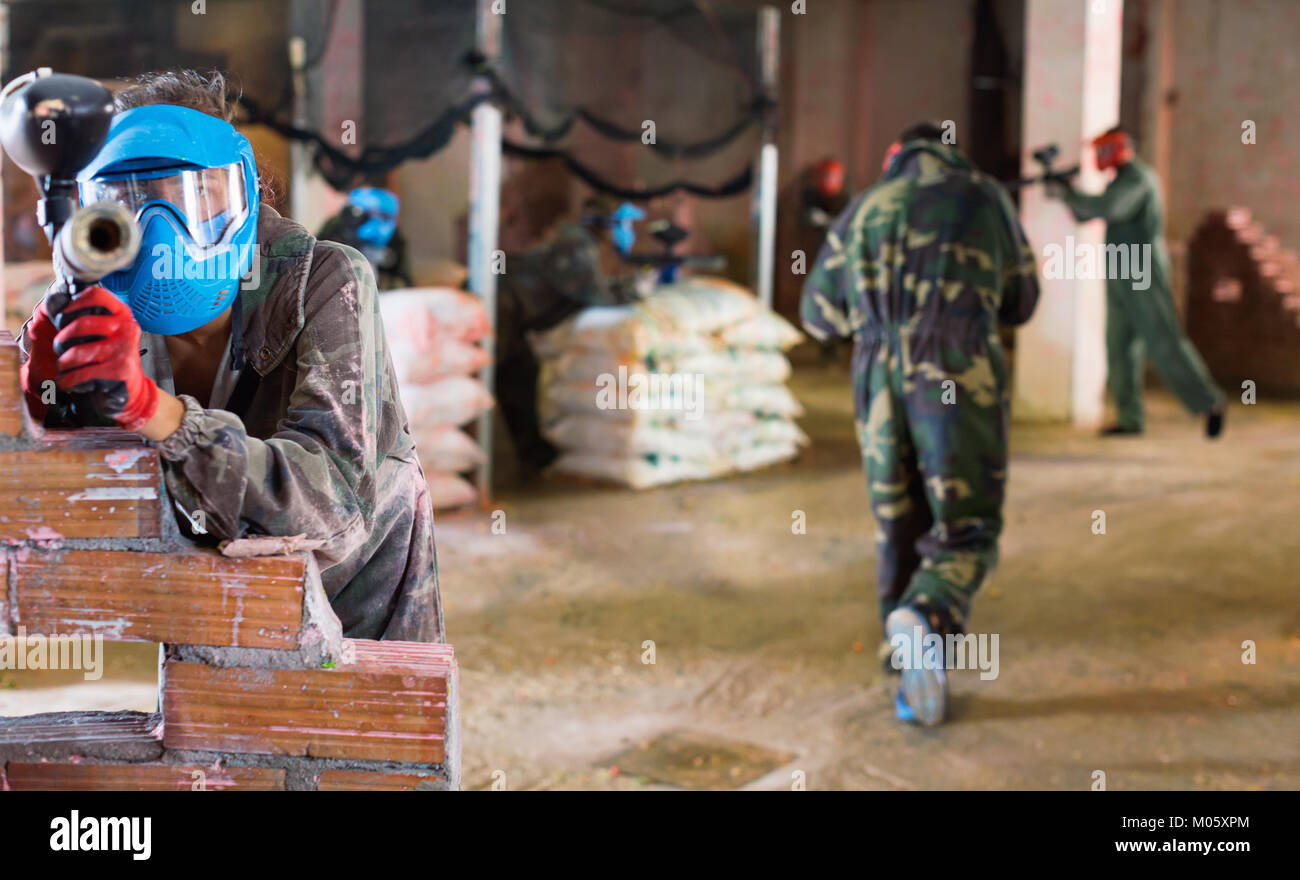 Portrait of blue team happy cheerful positive player who is aiming in ...