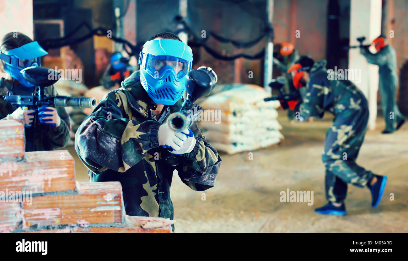 Portrait of blue team positive player who is aiming in opponents on ...