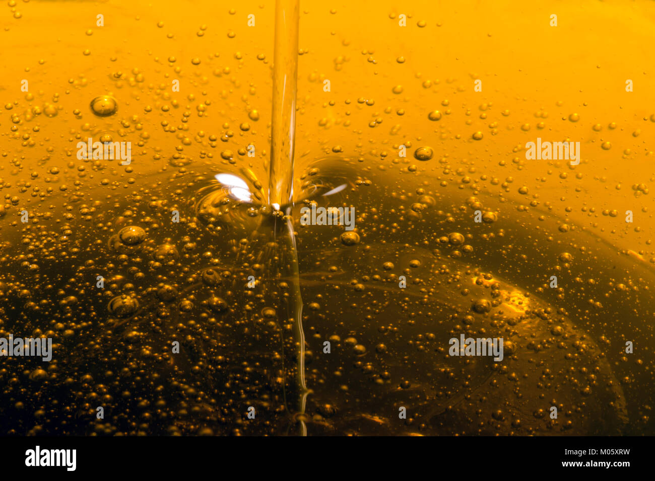 Close up view of pouring olive oil golden liquid Stock Photo - Alamy