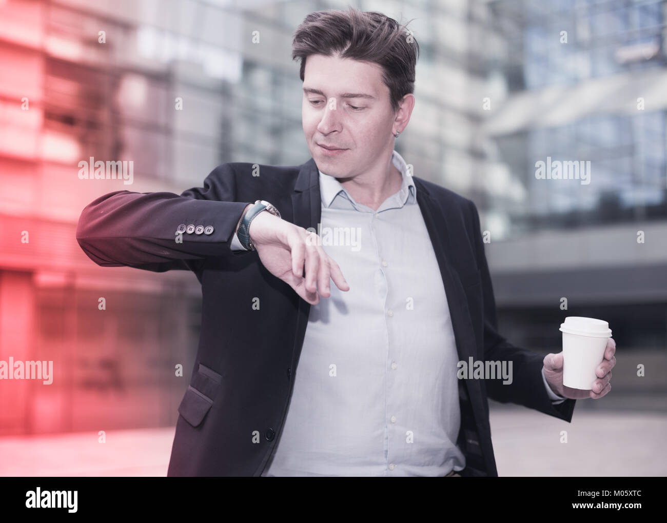 Businessman hurrying to meeting and watching on wristwatch Stock Photo ...