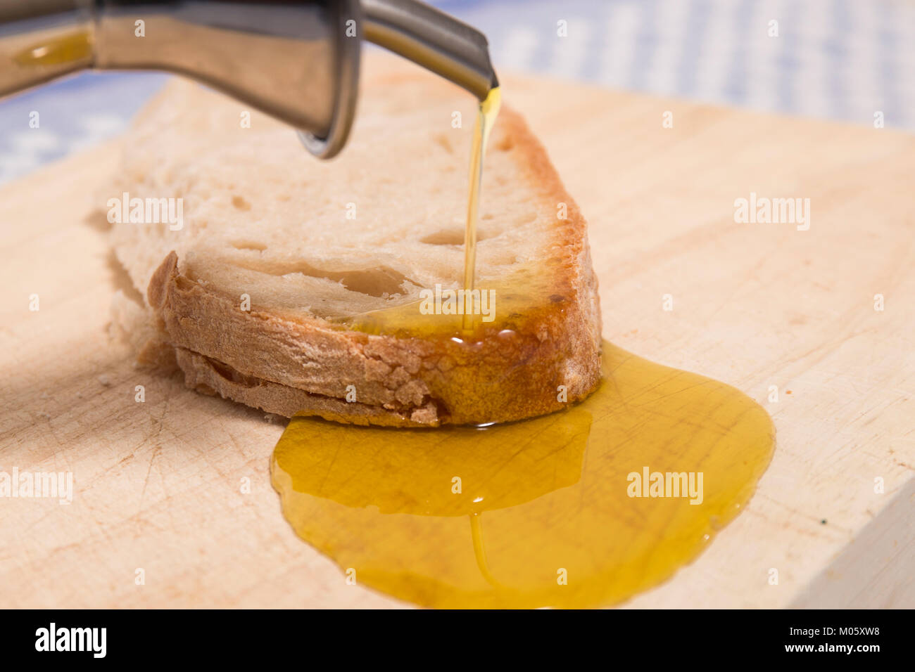 Pouring virgin olive oil on traditional Portuguese bread Stock Photo ...